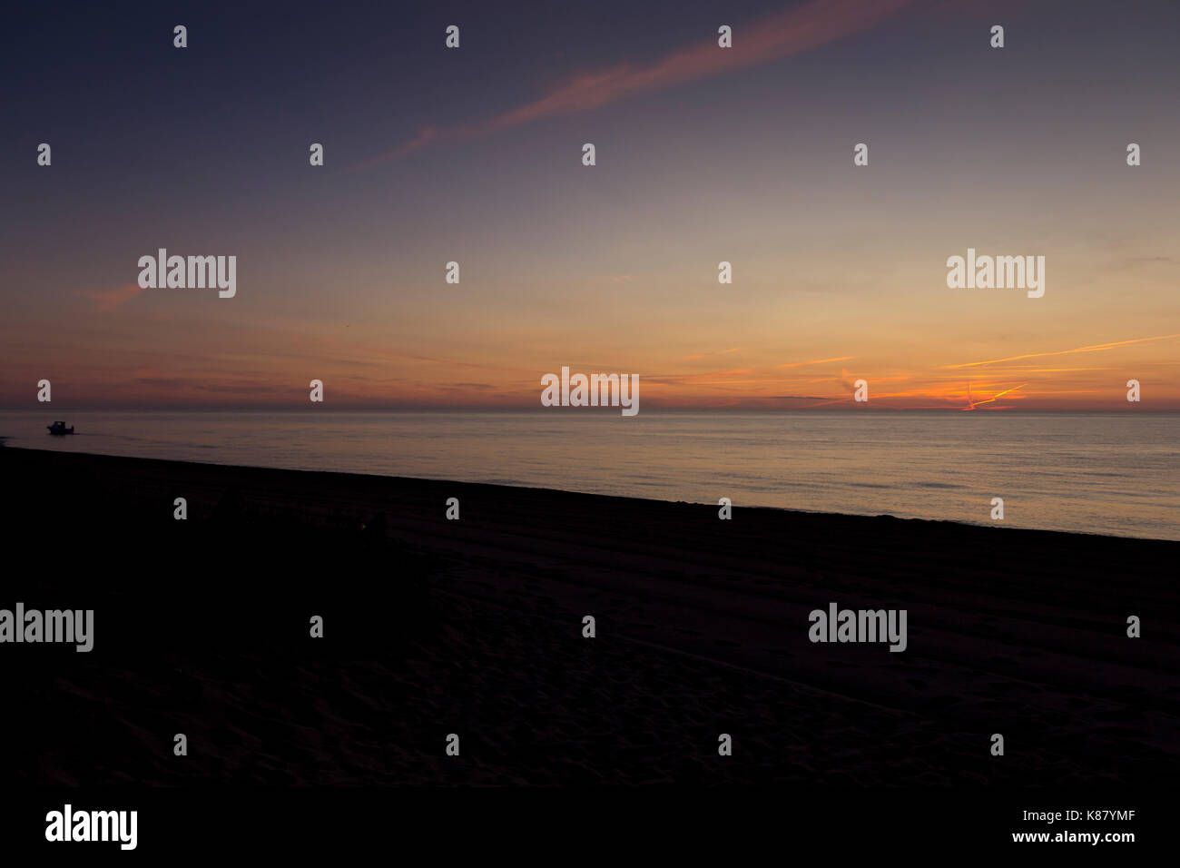 Dawn sun rising over a calm colorful Mediterranean sea Stock Photo - Alamy