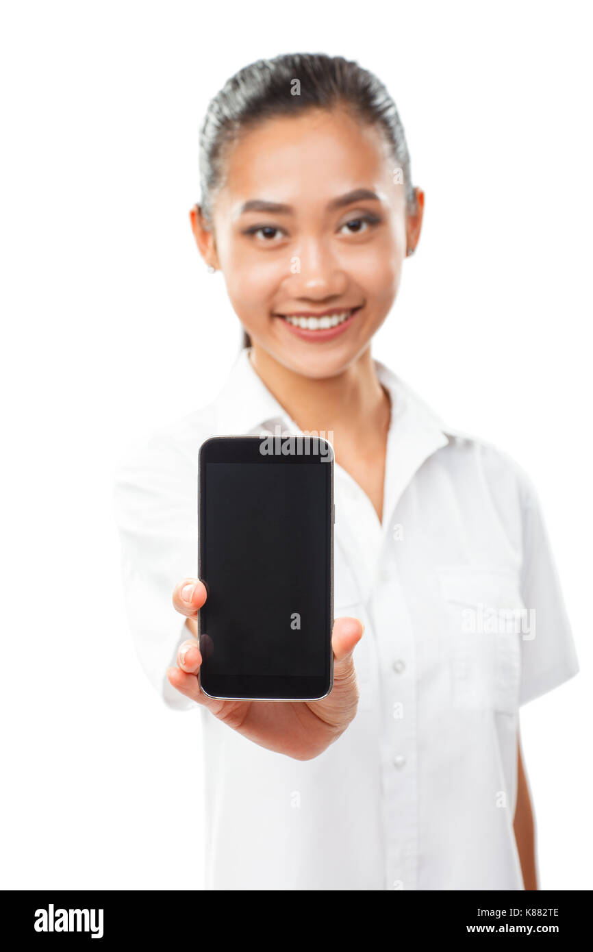 Friendly smiling young Asian woman showing black smartphone with blank ...
