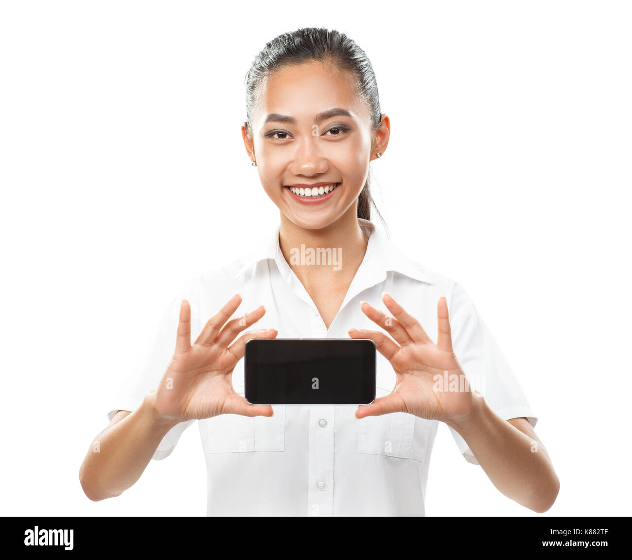 Friendly smiling young Asian woman showing black smartphone with blank ...