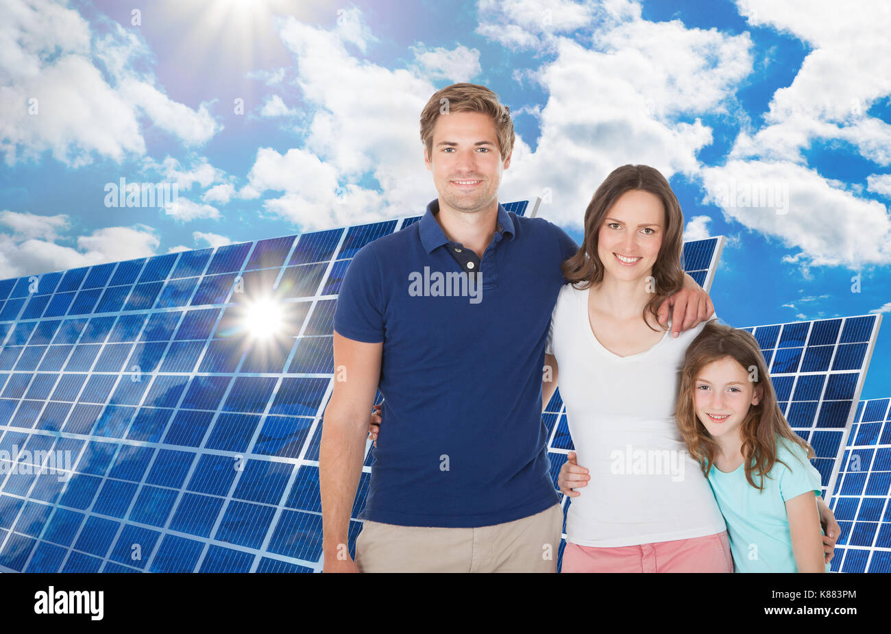 Happy Family Standing Near The Large Solar Panel Stock Photo - Alamy