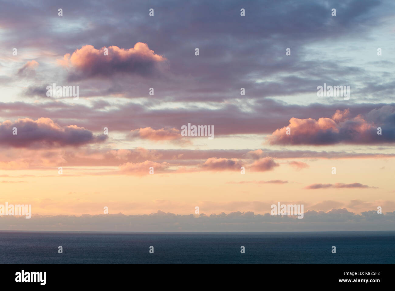 View from the land over the ocean, to the horizon. Sunset light shining ...