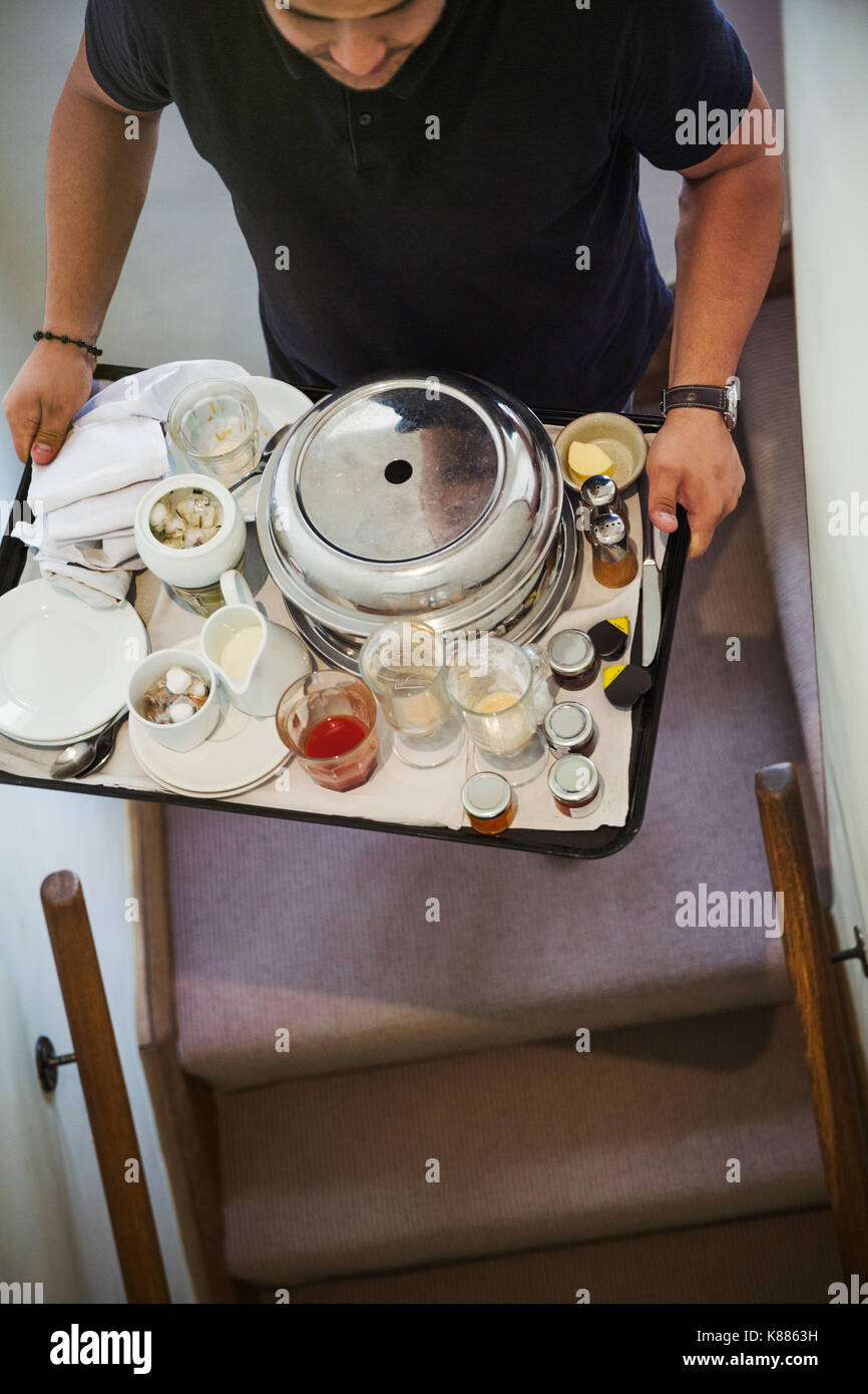 Waiter holding tray high hi-res stock photography and images - Alamy