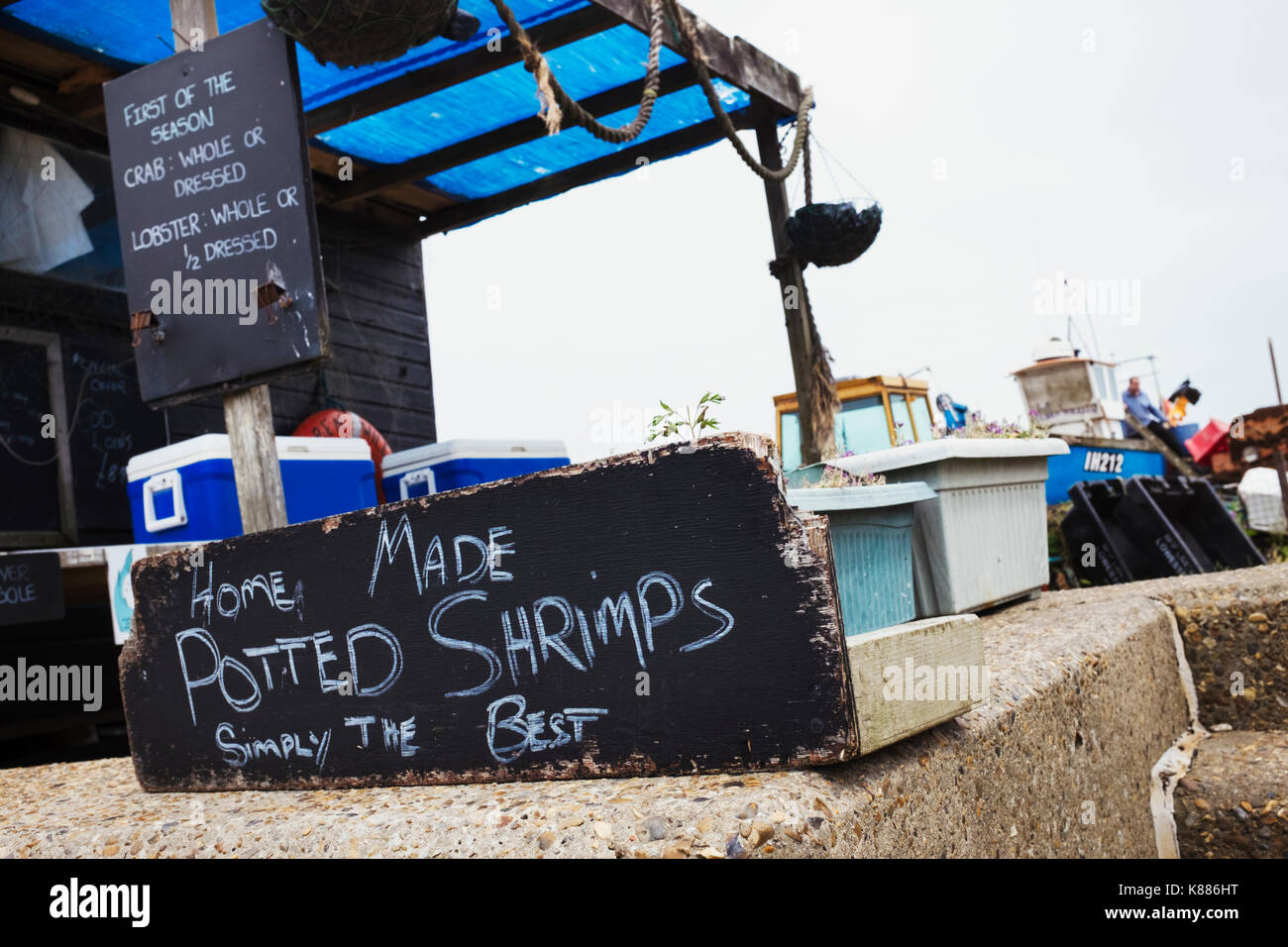 Handwritten sign advertising home made potted shrimp outside a fish ...