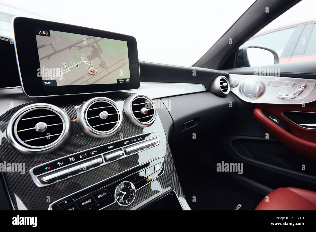 View from inside a car on a part of dashboard with a navigation unit ...