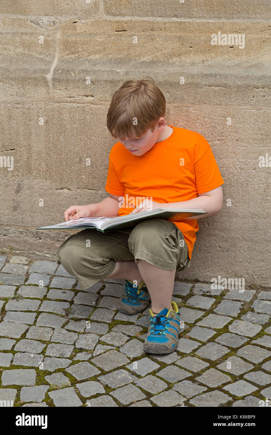 young boy reading a book Stock Photo - Alamy