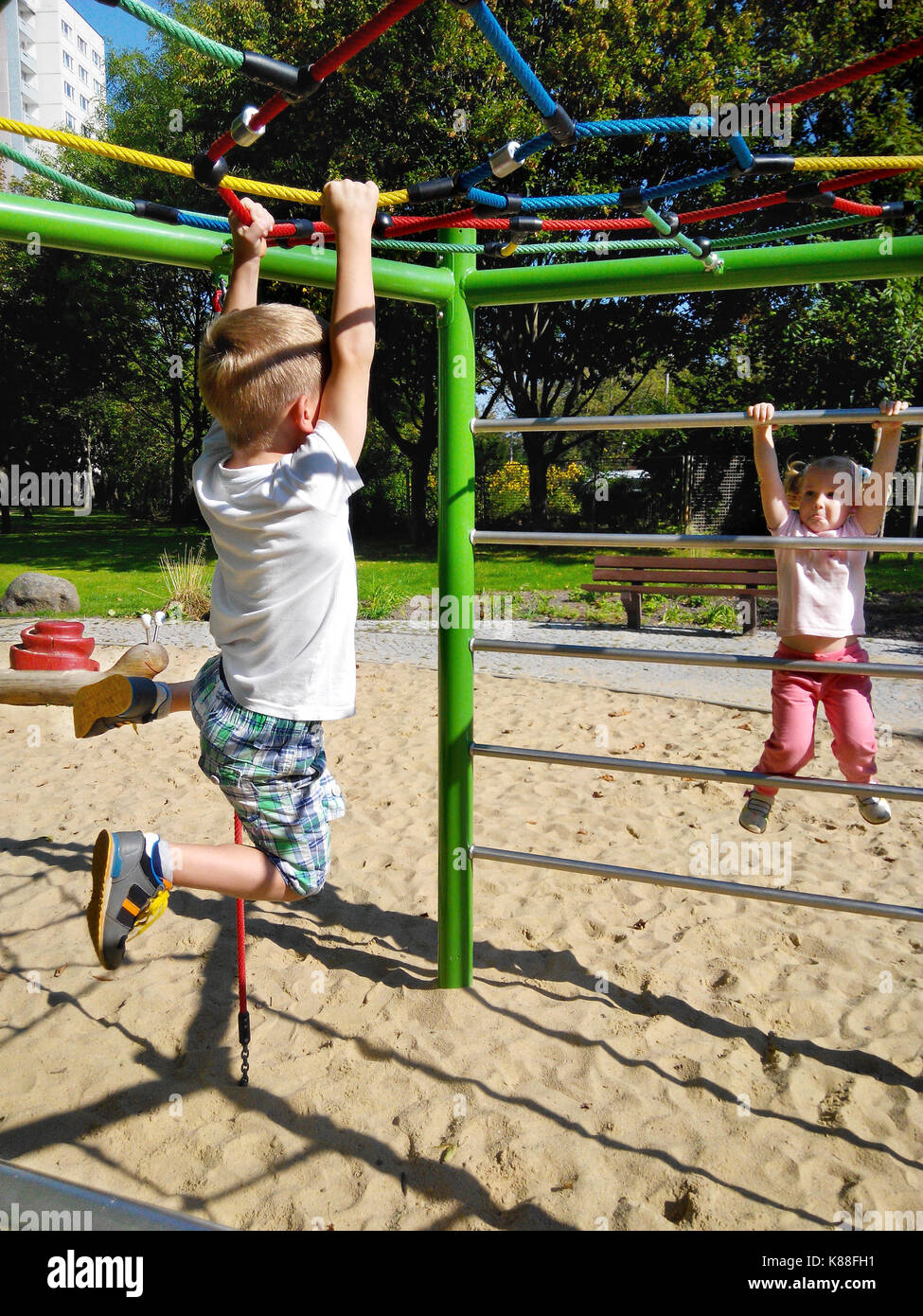 Little excited children playing at sandy playground Stock Photo - Alamy