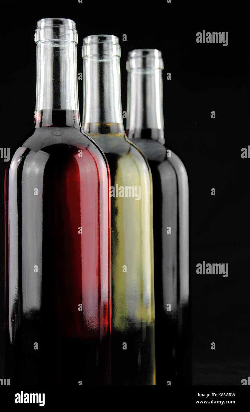 Three colors of wine in bottles Stock Photo - Alamy