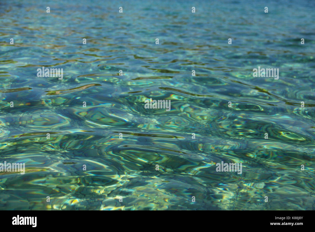 Beautiful background of crystal clear transparent sea water at sunny ...