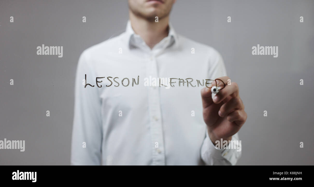 Lesson learned , Man Writing on Glass Stock Photo - Alamy