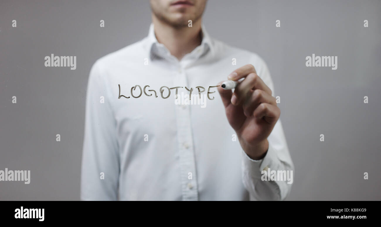Logotype , Man Writing on Glass Stock Photo - Alamy