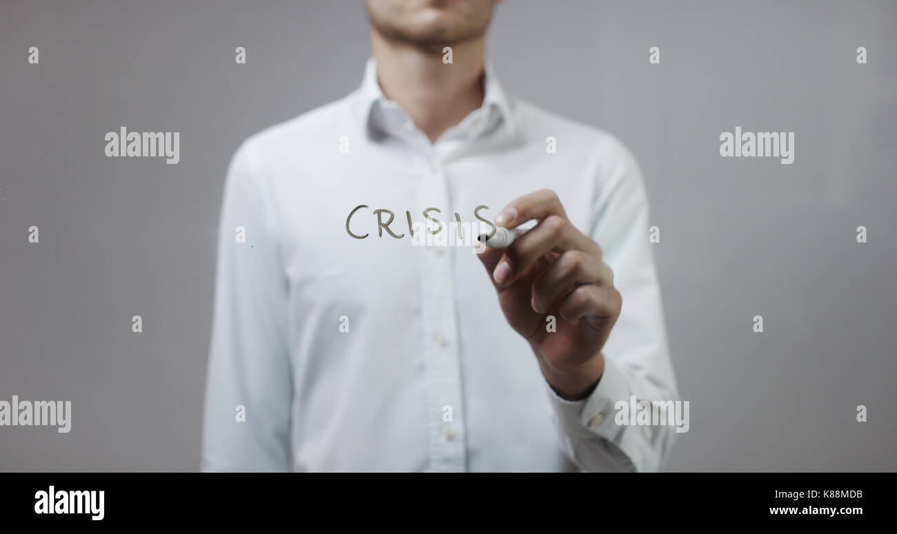 Crisis , Man Writing on Glass Stock Photo - Alamy