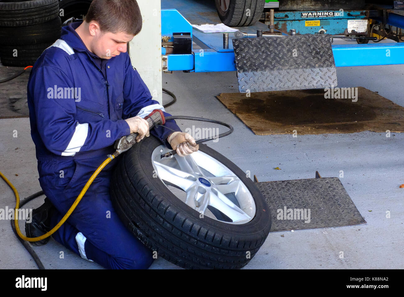 Garage Car Mechanic Changing Tyre Stock Photos & Garage Car Mechanic ...