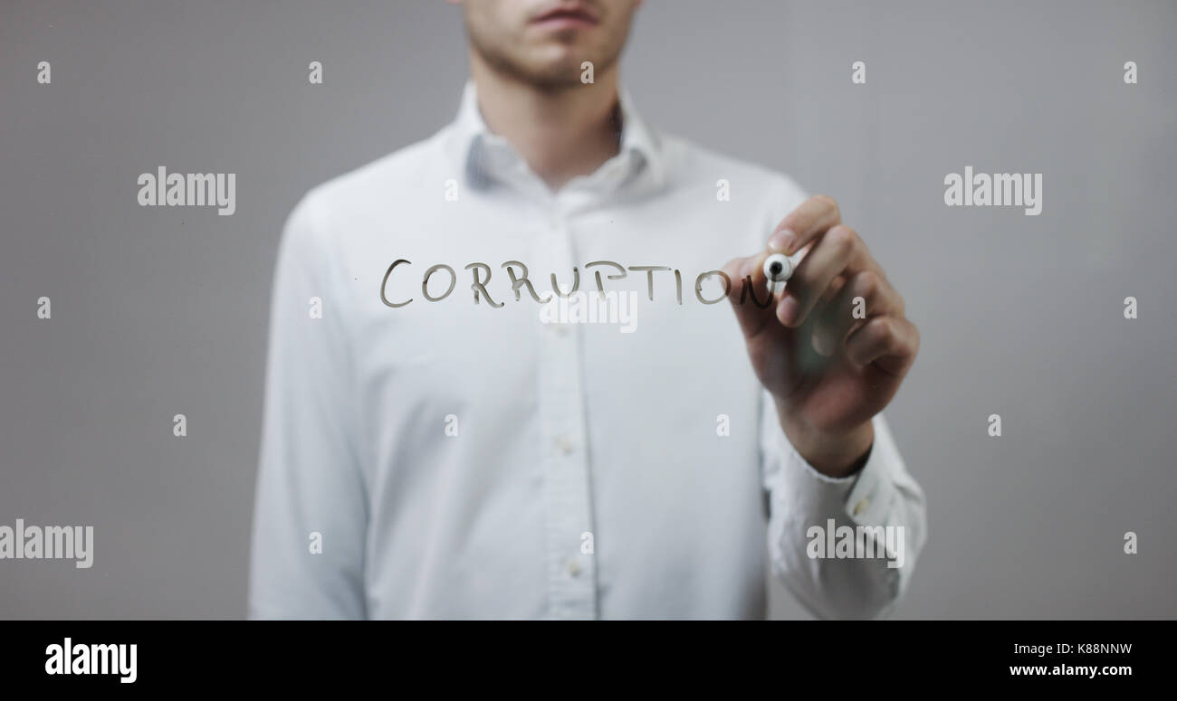 Corruption , Man Writing on Glass Stock Photo - Alamy