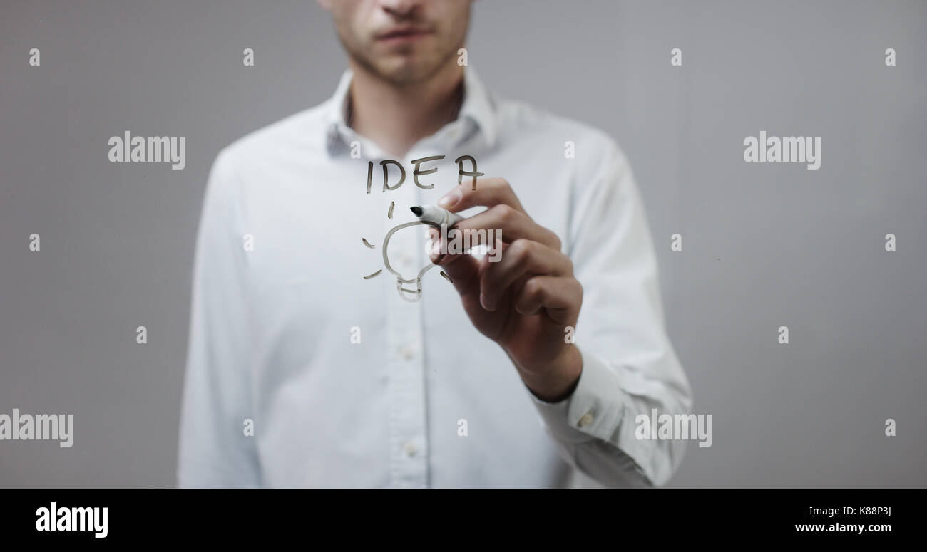 Idea , Man Writing on Glass Stock Photo - Alamy