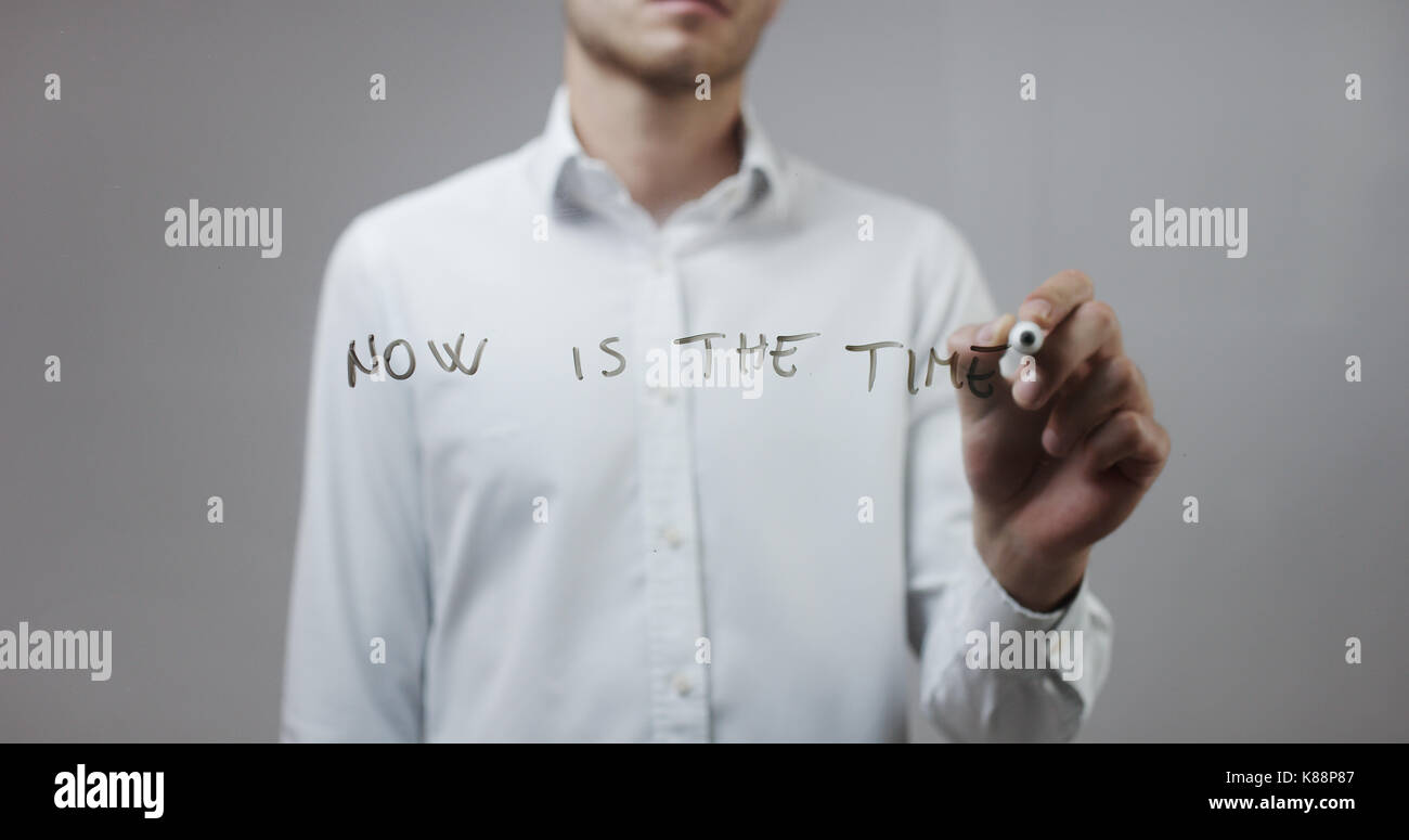 Now is the time , Man Writing on Glass Stock Photo - Alamy