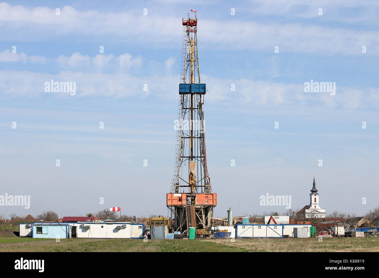 land oil drilling rig with workers near village Stock Photo - Alamy