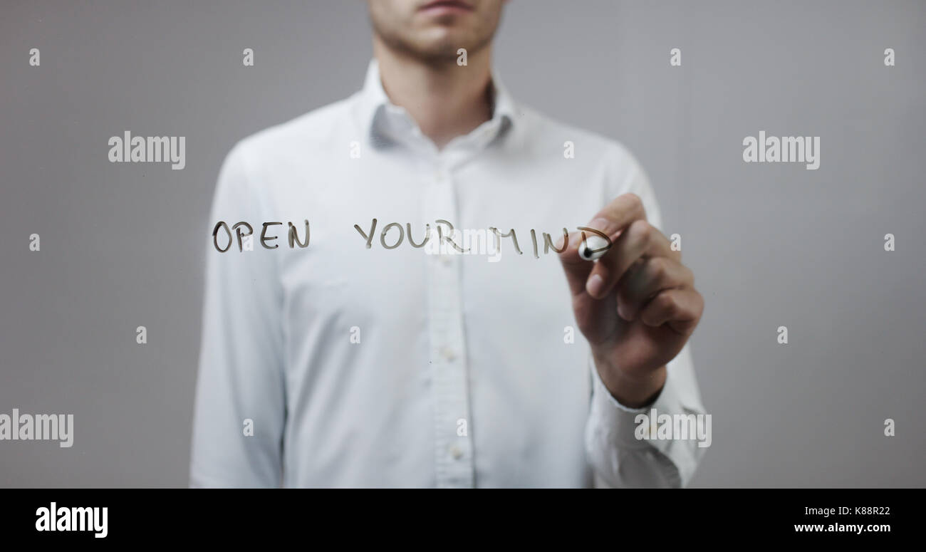 Open your mind , Man Writing on Glass Stock Photo - Alamy