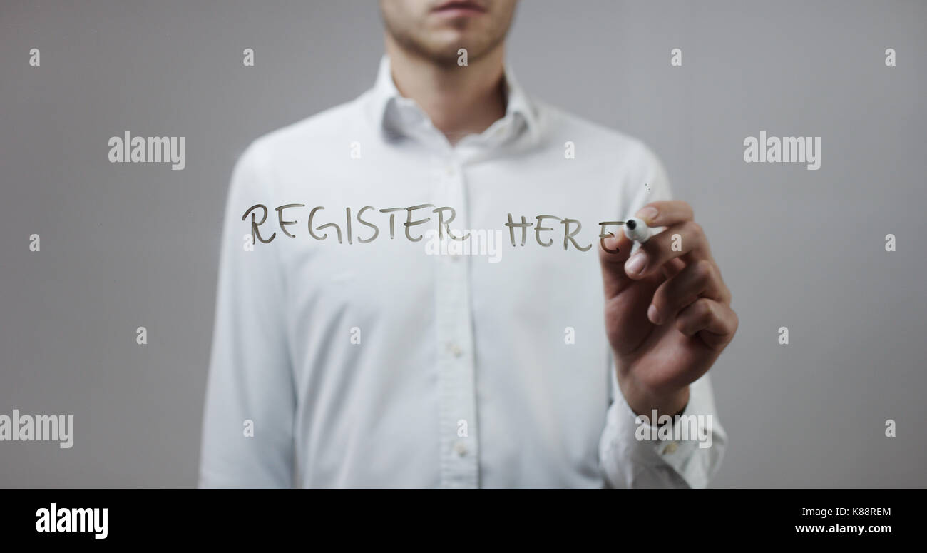 Register here , Man Writing on Glass Stock Photo - Alamy