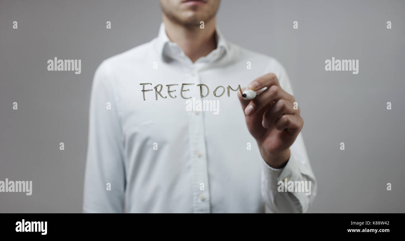 Freedom , Man Writing on Glass Stock Photo - Alamy