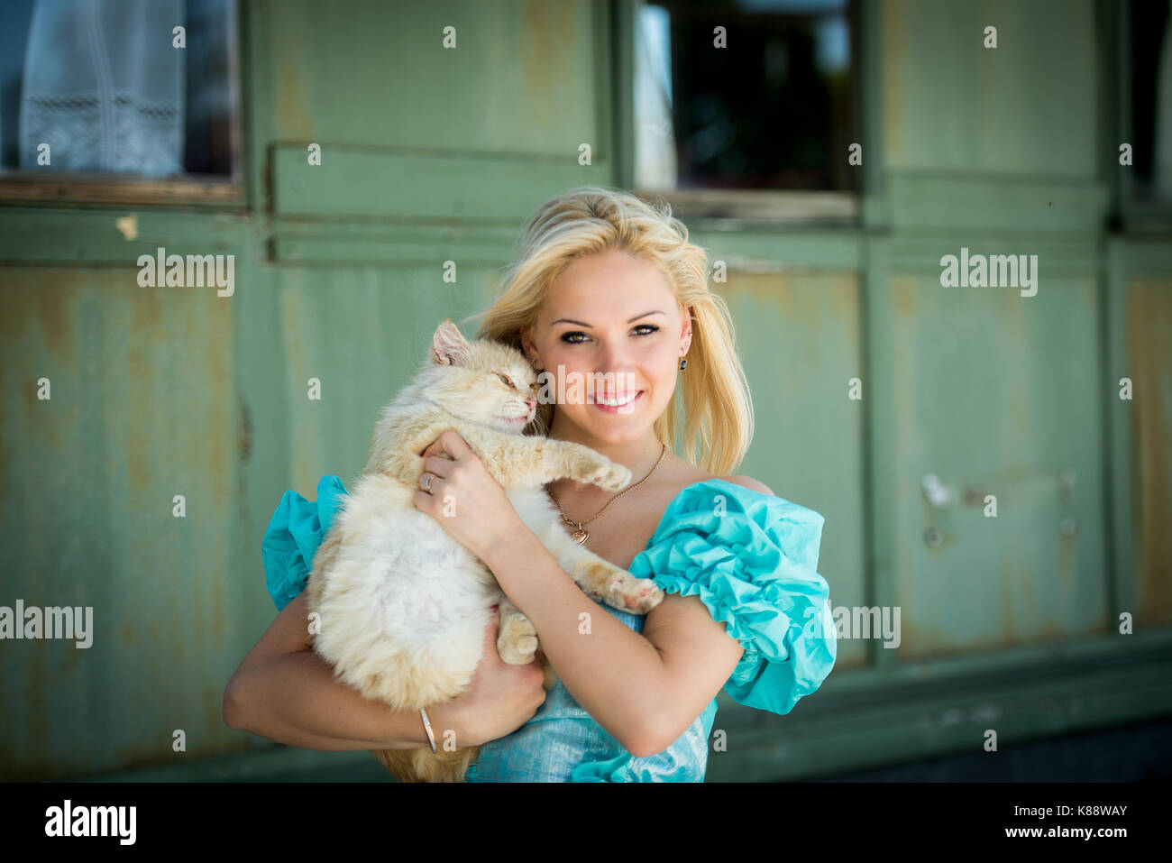 Portrait of beautiful young woman with cute cat Stock Photo - Alamy