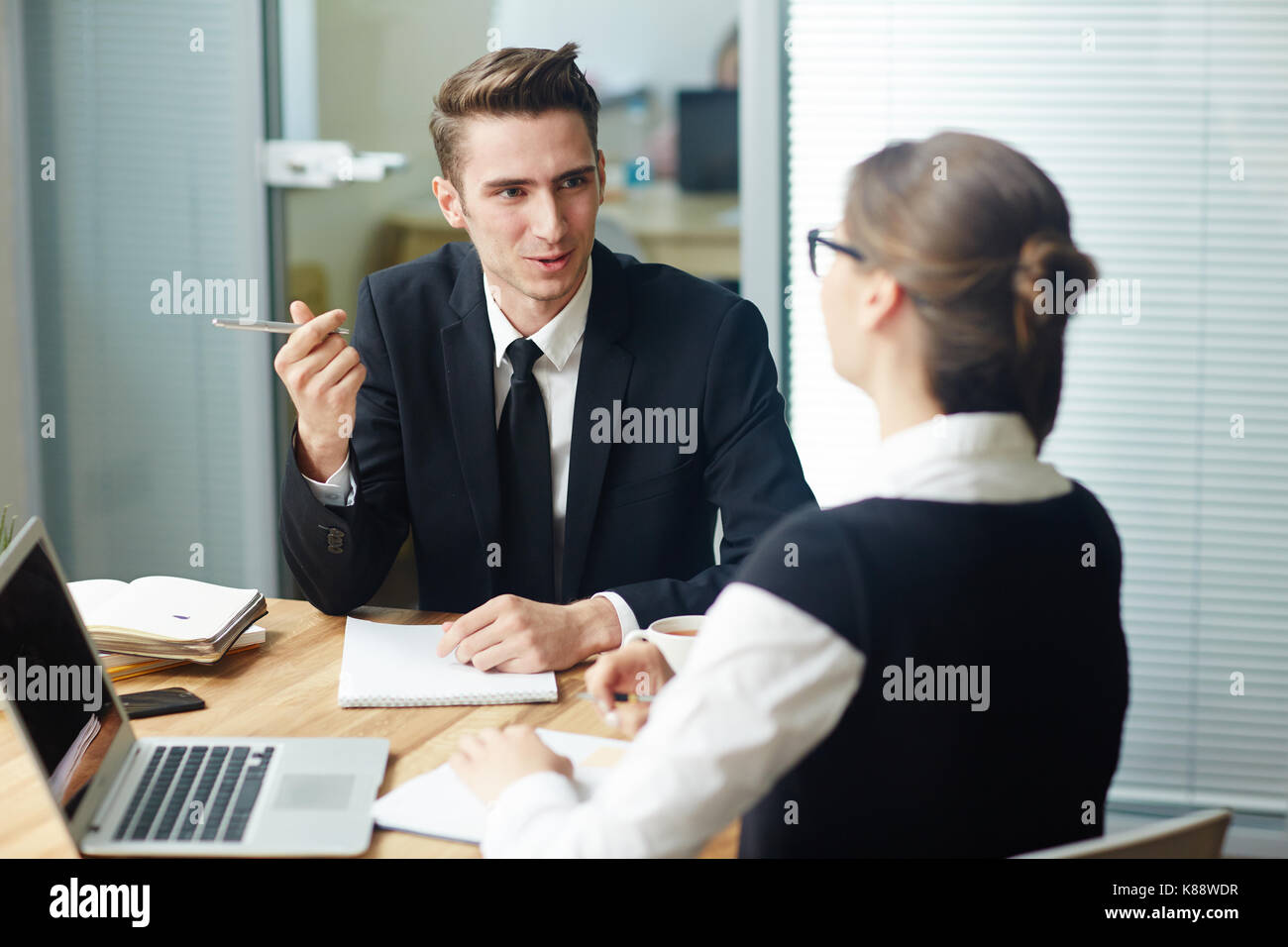 Group of young financial managers in formalwear gathered together at ...