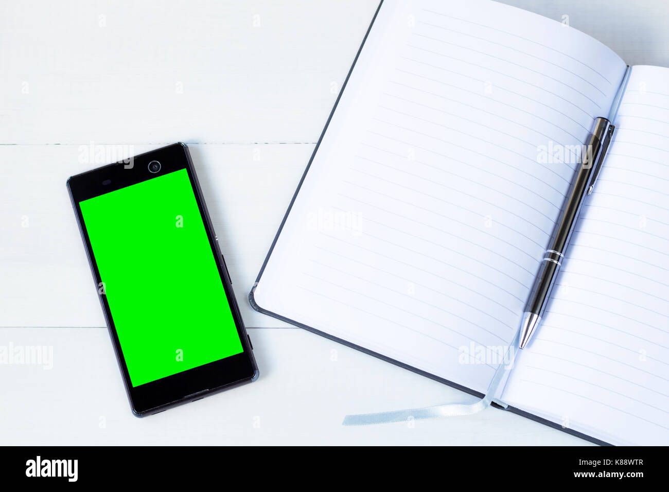smart phone with green screen with notepad Stock Photo - Alamy