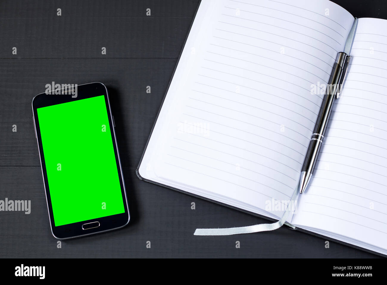 smart phone with green screen with notepad Stock Photo - Alamy