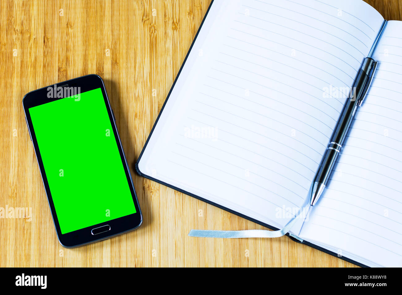 smart phone with green screen with notepad Stock Photo - Alamy