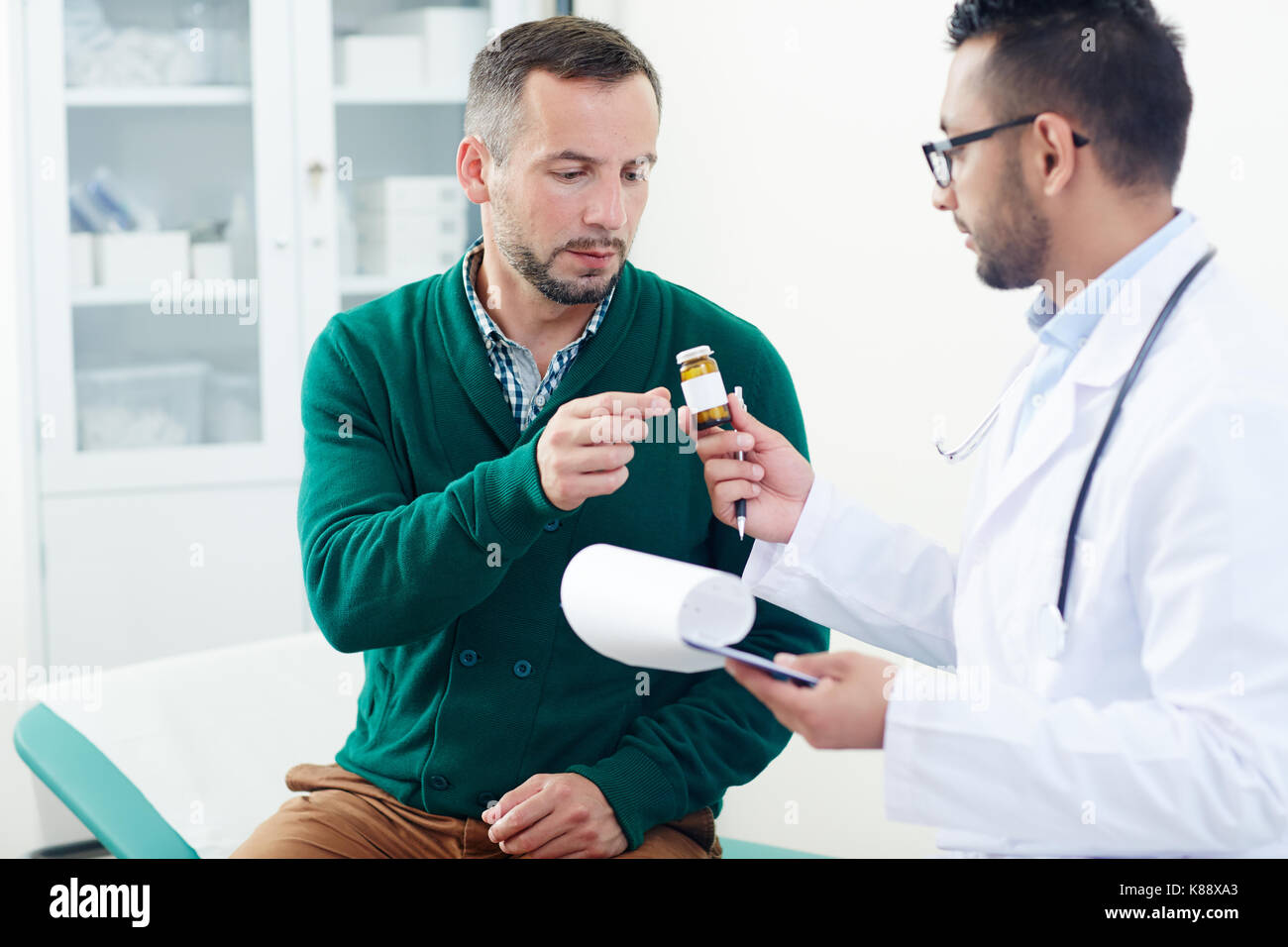 Doctor prescribing medicine during medical hi-res stock photography and ...