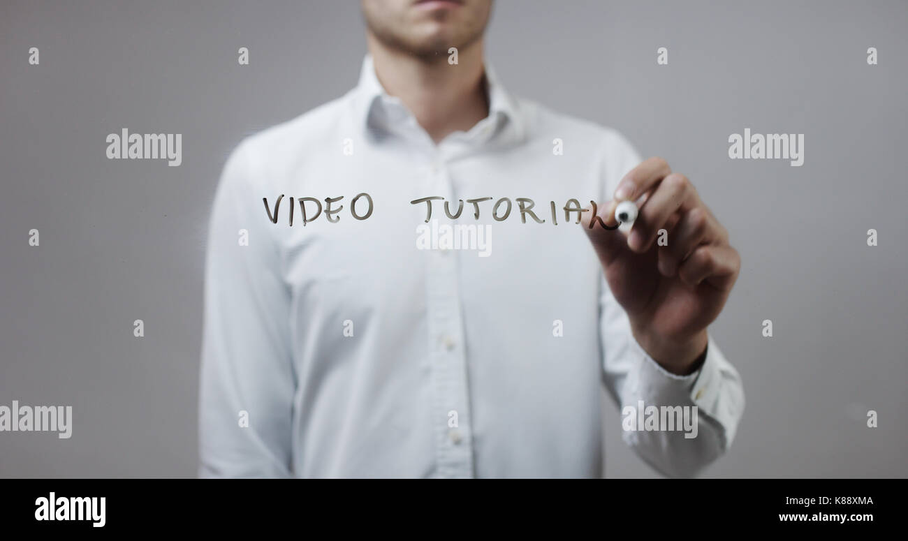 Video tutorial , Man Writing on Glass Stock Photo - Alamy