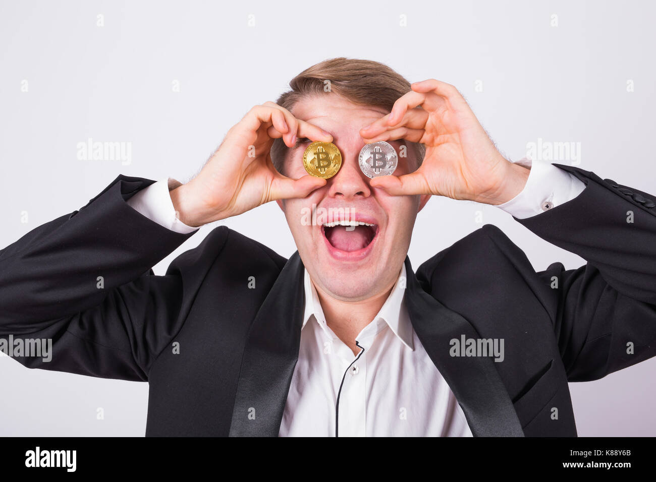 Crazy bitcoin lover with golden and silver coins by eyes, funny miner ...
