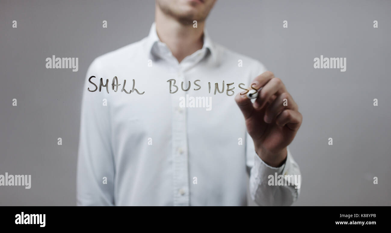 Small business , Man Writing on Glass Stock Photo - Alamy