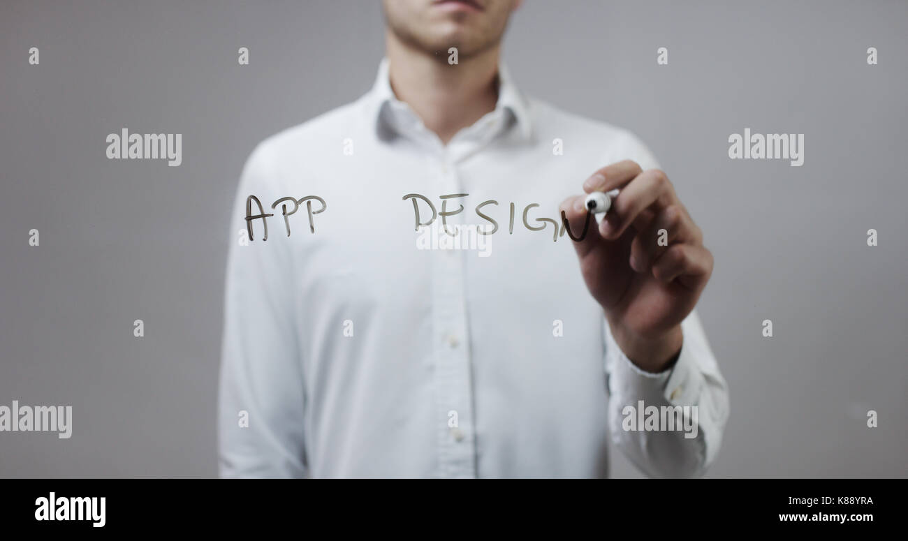 App design , Man Writing on Glass Stock Photo - Alamy