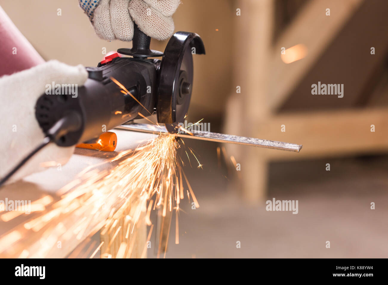 Heavy industry worker cutting steel with angle grinder Stock Photo - Alamy