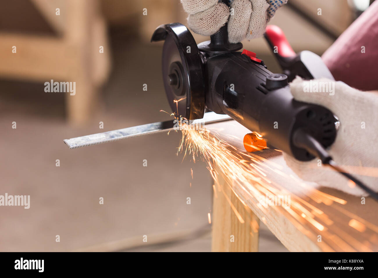 Heavy industry worker cutting steel with angle grinder Stock Photo - Alamy