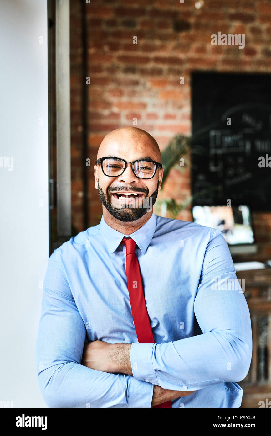 Businessman leaning against office wall hi-res stock photography and ...
