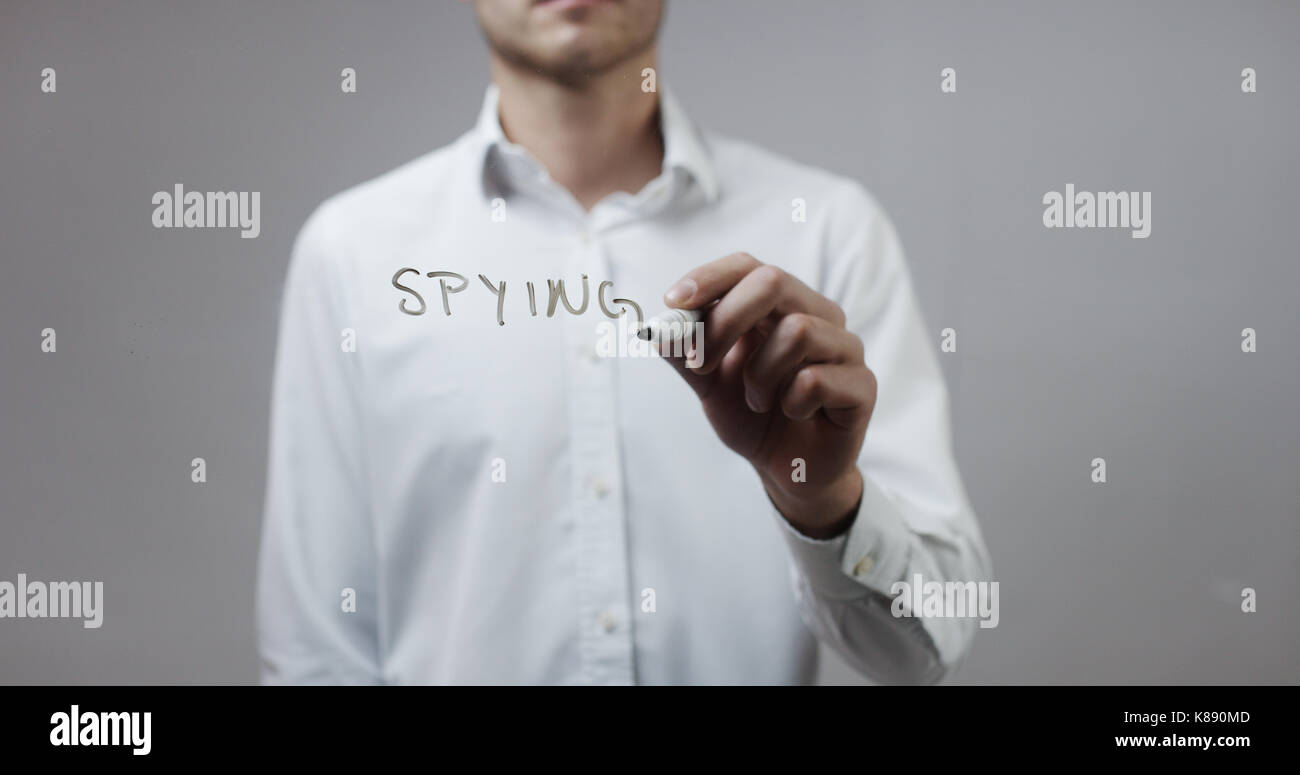 Spying , Man Writing on Glass Stock Photo - Alamy