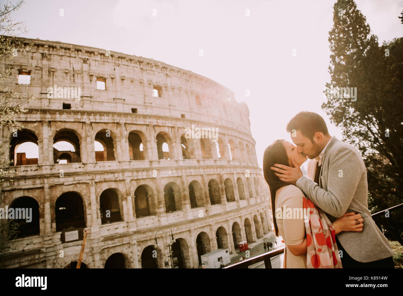 Loving couple visiting Italian famous landmarks Colosseum in Rome ...