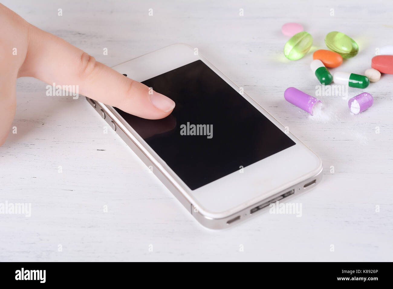 Close-up of female using smartphone with pills. Medicine and technology ...