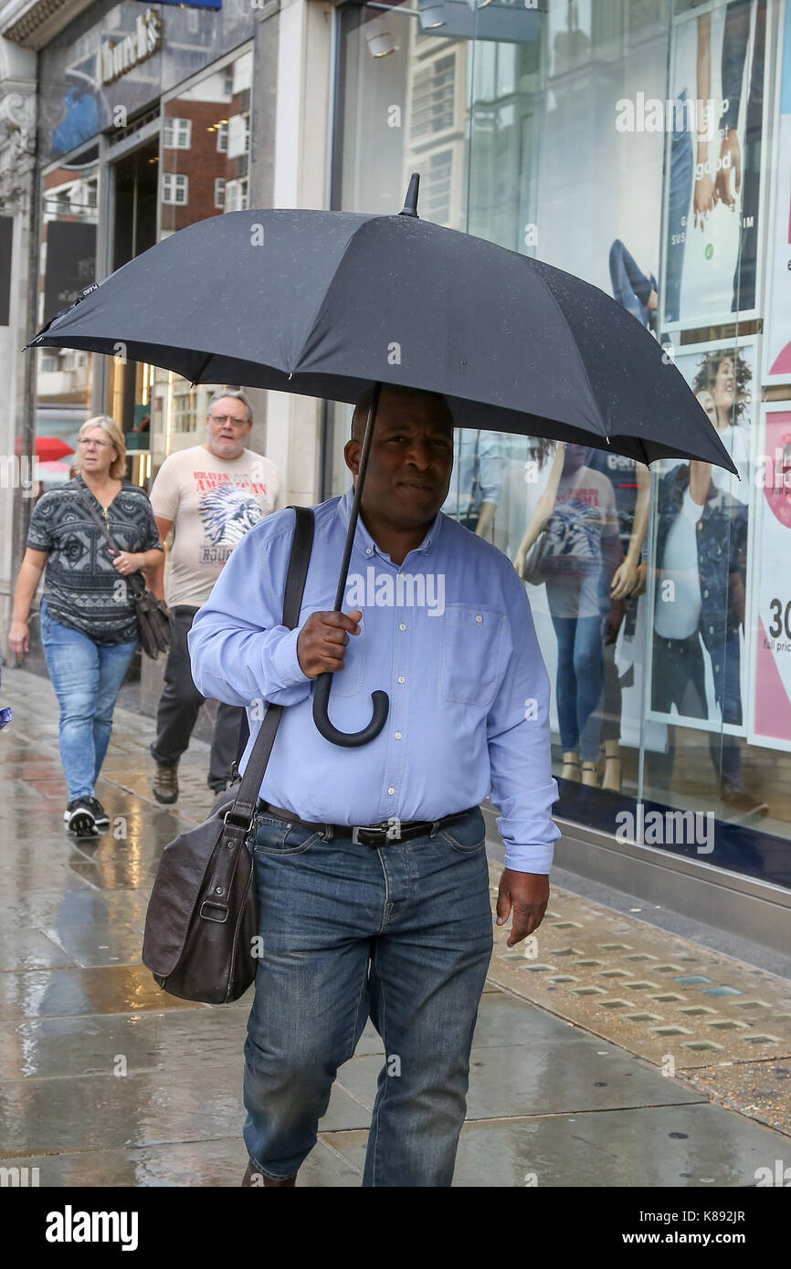 People shelter from the rain under umbrellas in Knightsbridge Featuring ...