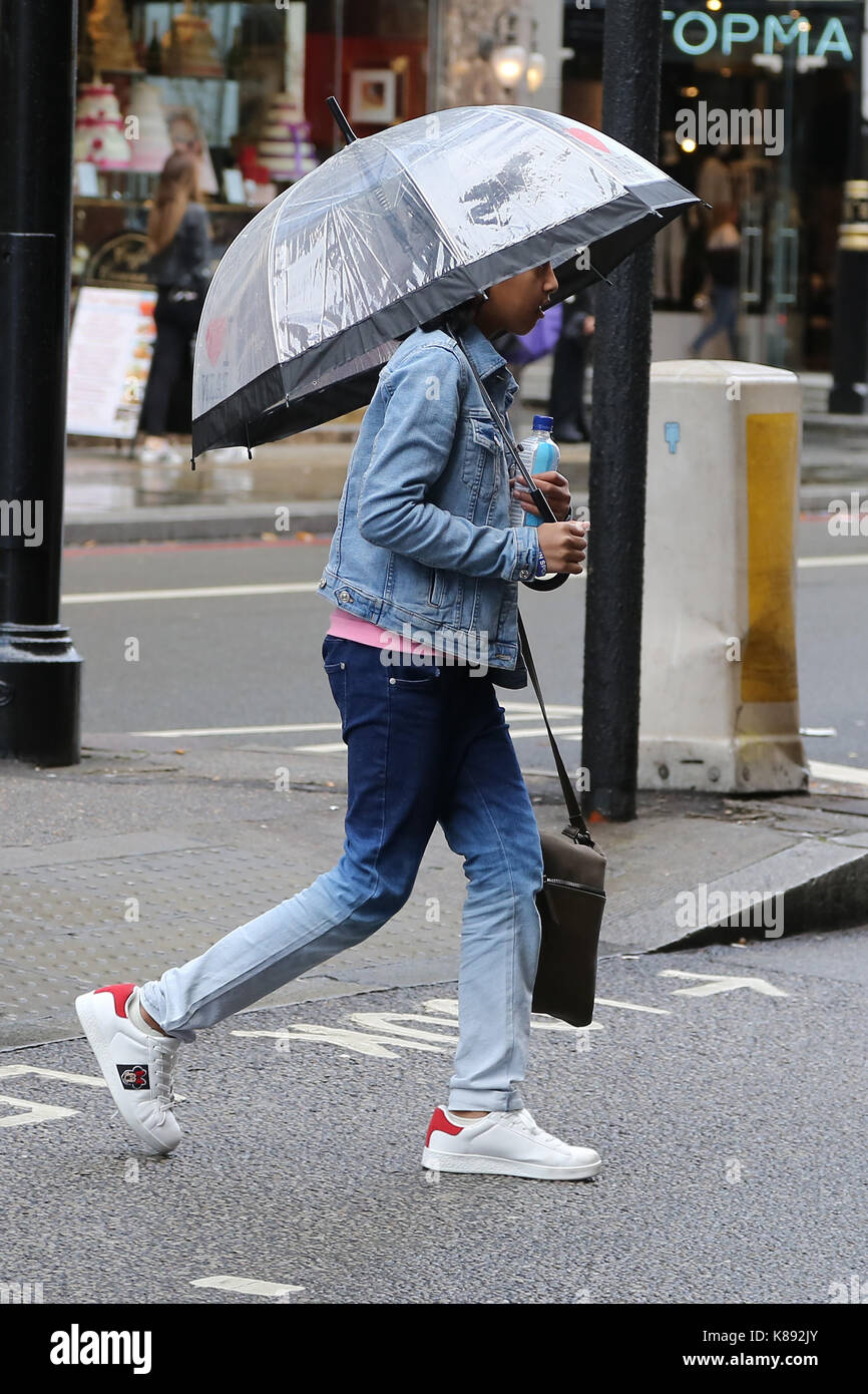People shelter from the rain under umbrellas in Knightsbridge Featuring ...