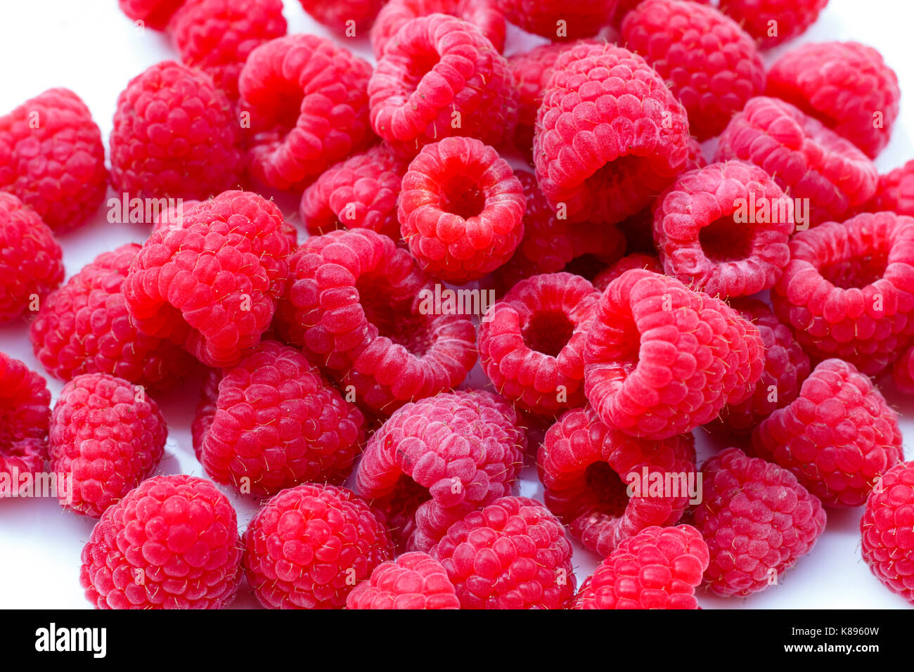 Raspberries isolated in a white background Stock Photo - Alamy