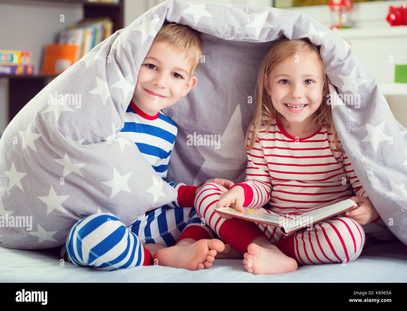 Boy Reading Book Under Covers High Resolution Stock Photography and ...