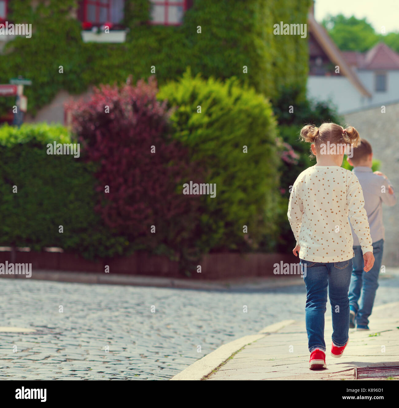 Two kids walking hand in hand hi-res stock photography and images - Alamy