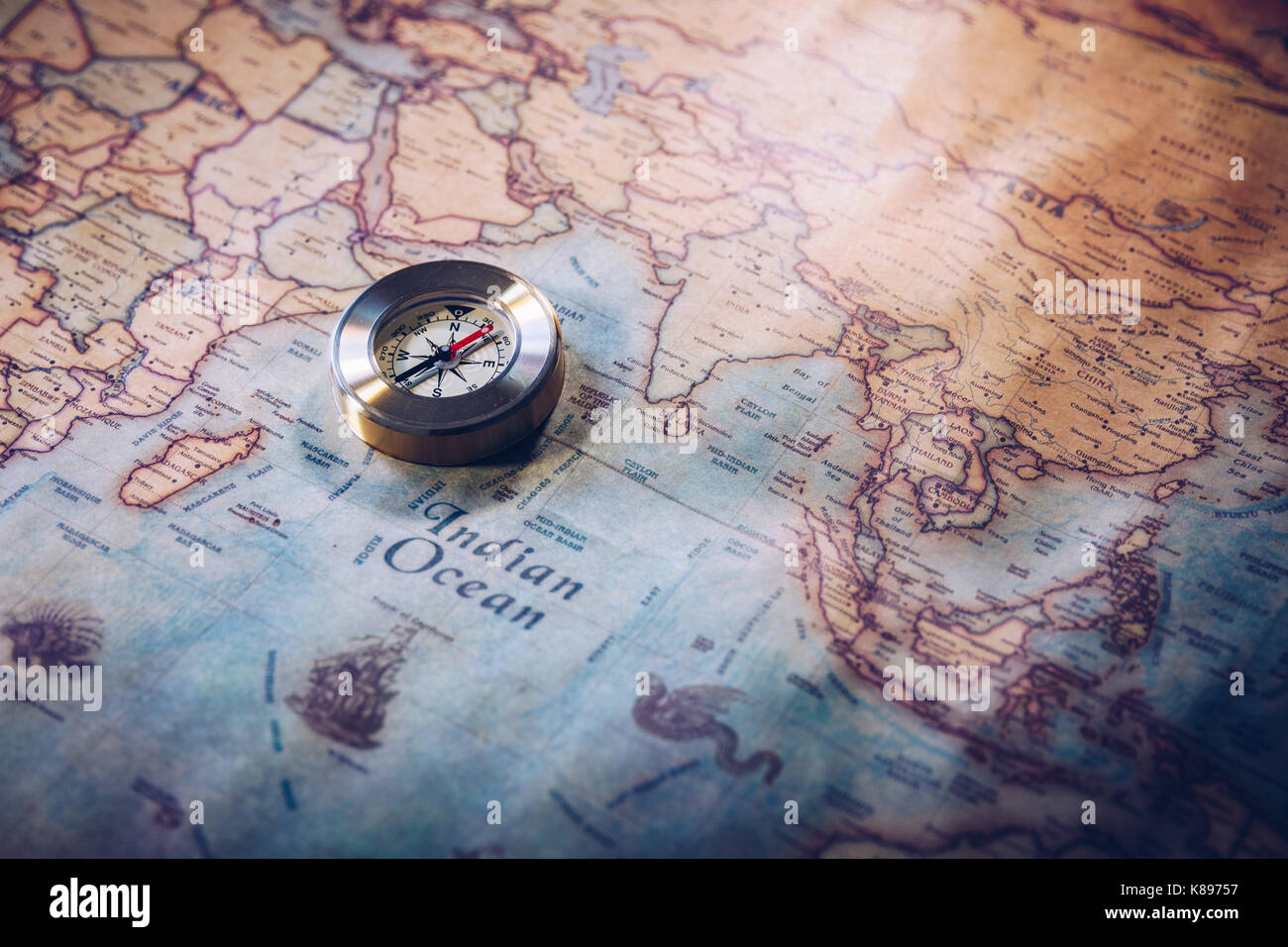Old vintage retro golden compass on ancient map. Selective focus ...