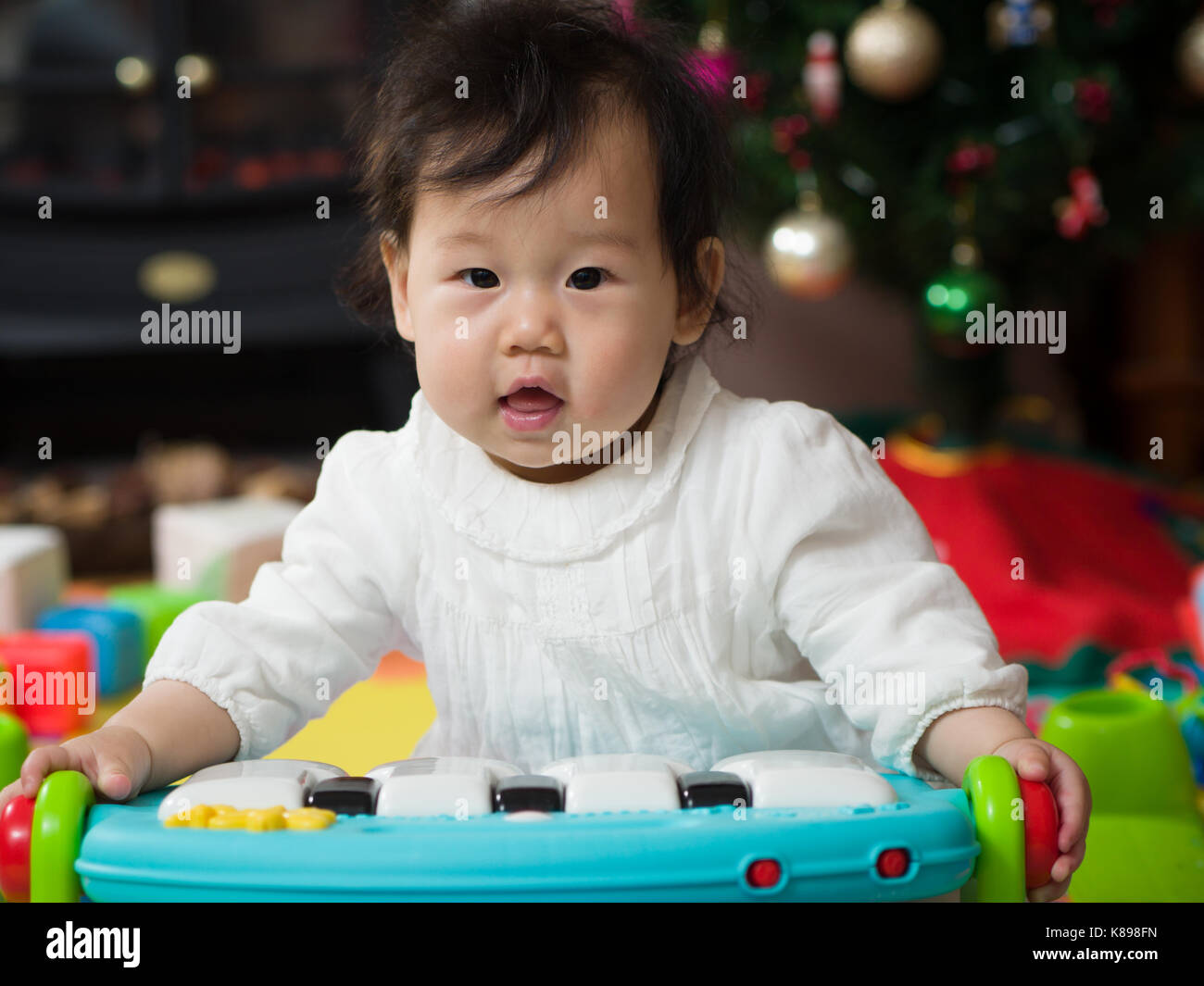 Baby girl playing toy piano at home hi-res stock photography and images ...