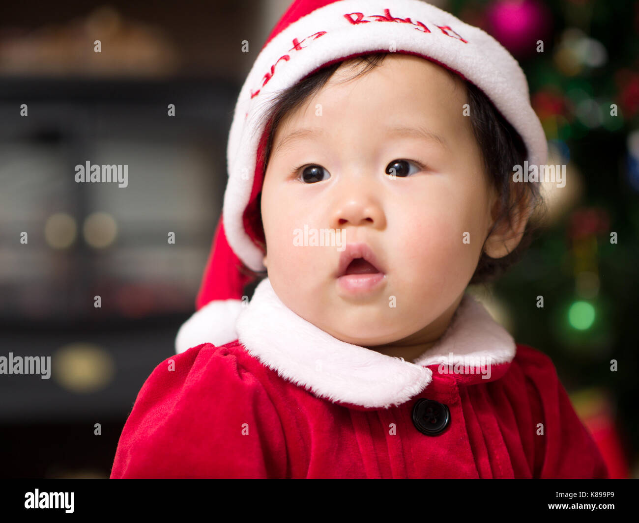 Asian baby girl in a Santa costume Stock Photo - Alamy