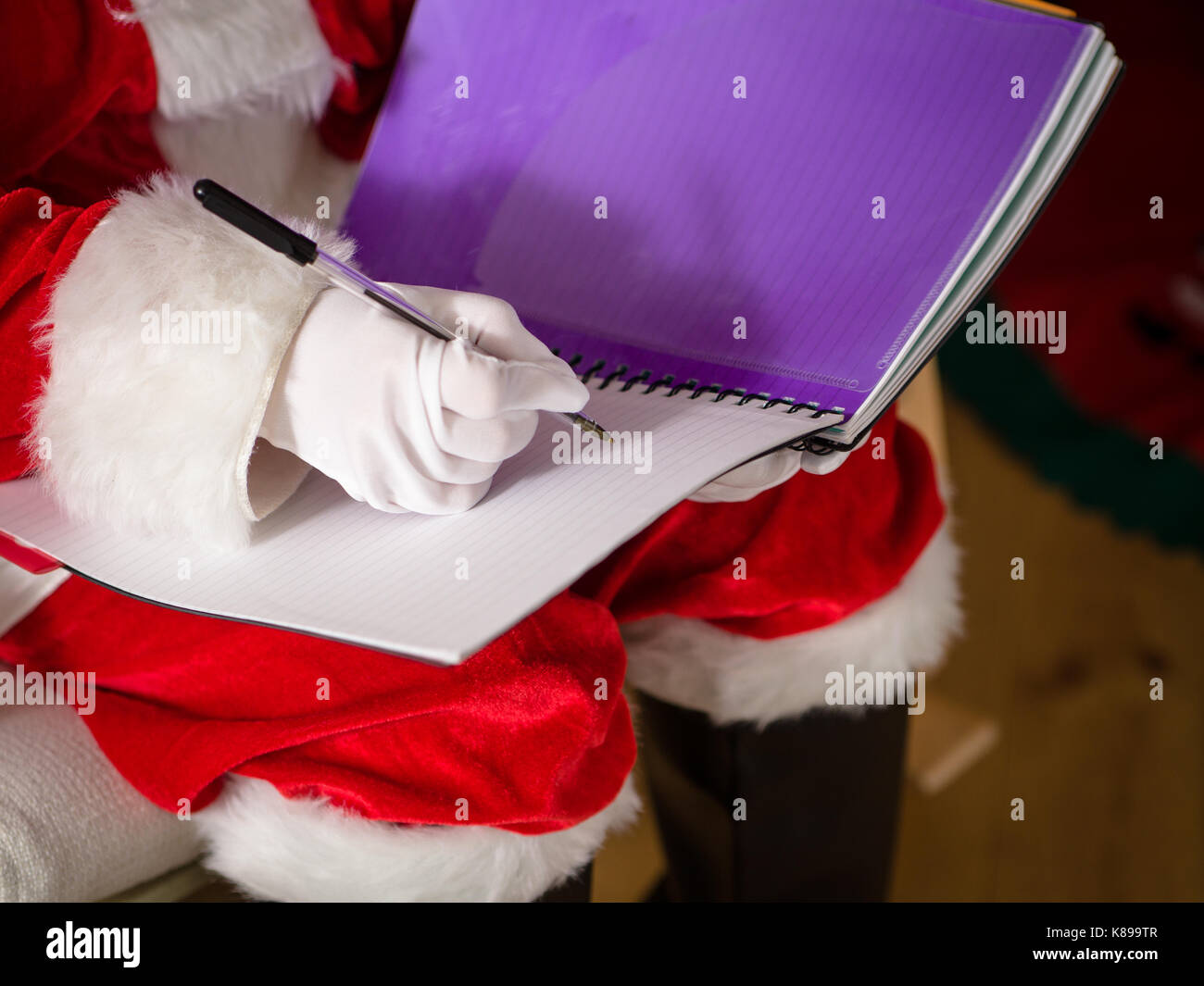 Santa making a gift list Stock Photo - Alamy