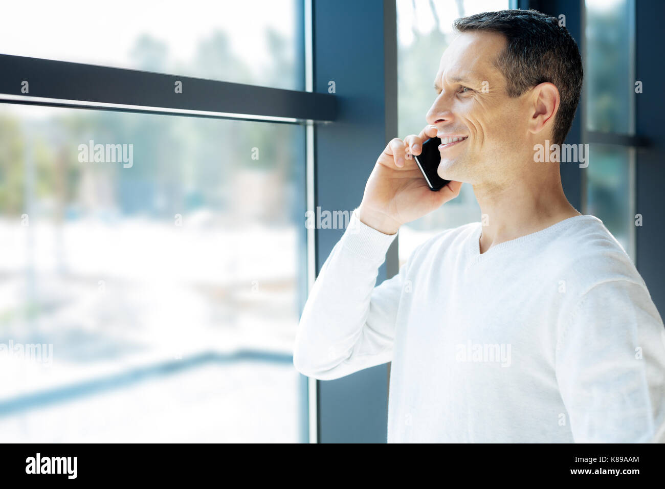 Joyful positive man talking with his friend Stock Photo - Alamy Joyful positive man talking with his friend Stock Photo - Alamy