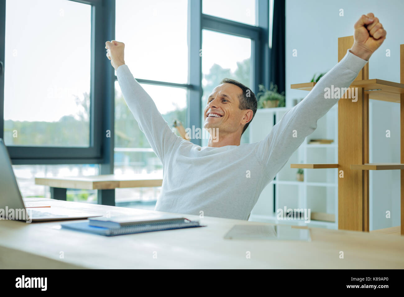 Happy positive man holding his hands up Stock Photo - Alamy